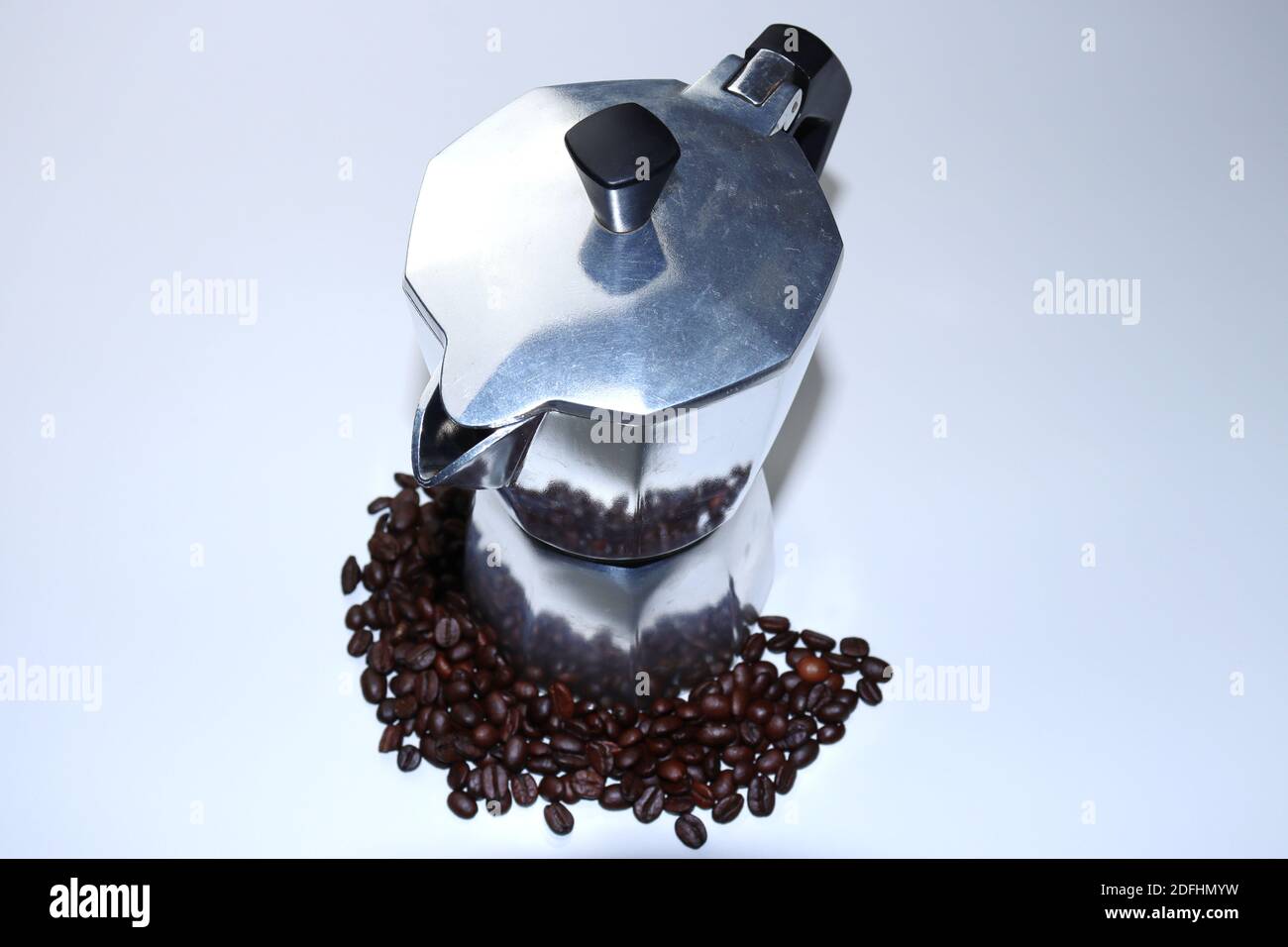 Moka pot with coffee beans on a white background. Moka coffee maker ...