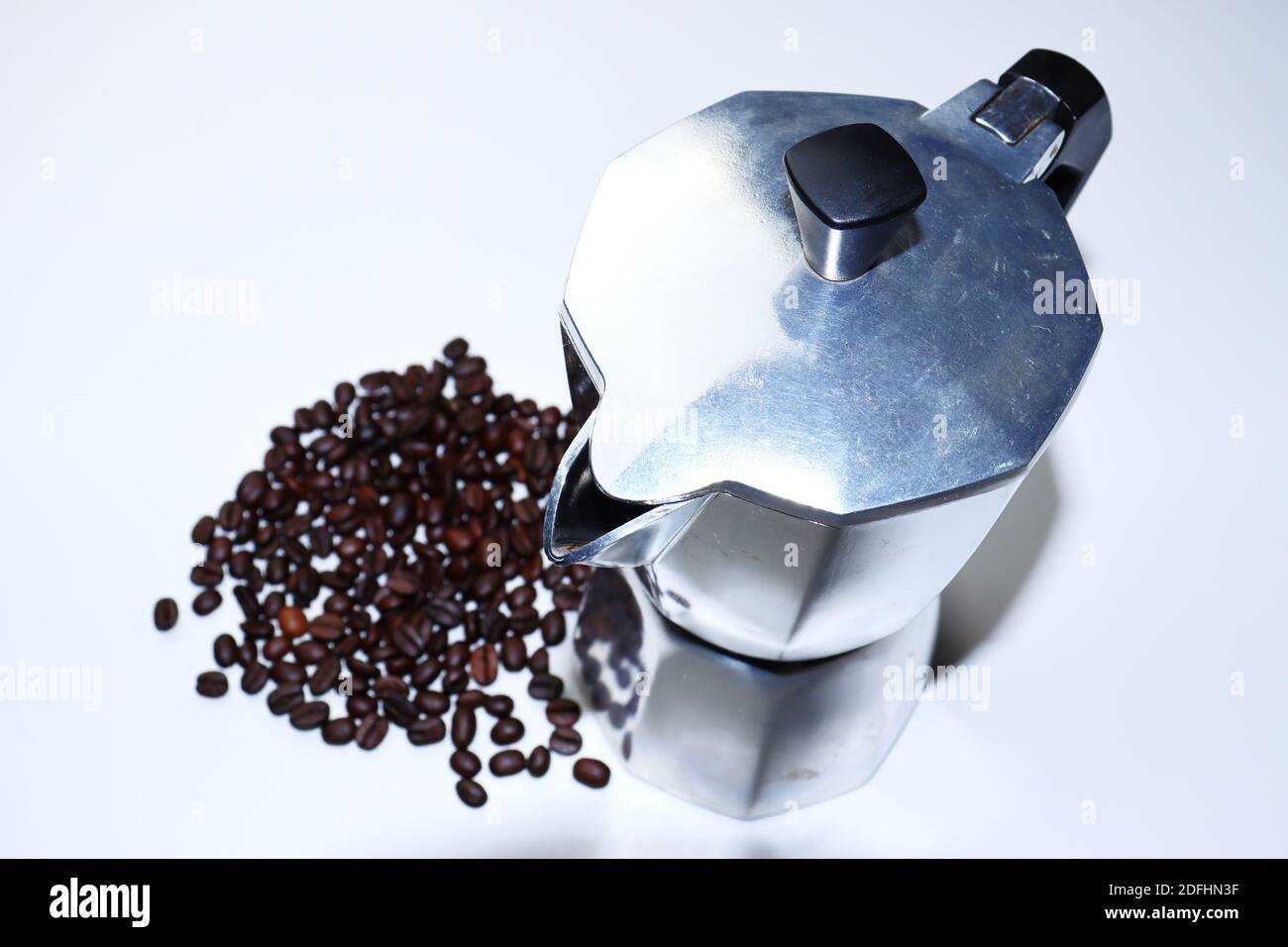 Moka pot with coffee beans on a white background. Moka coffee maker ...