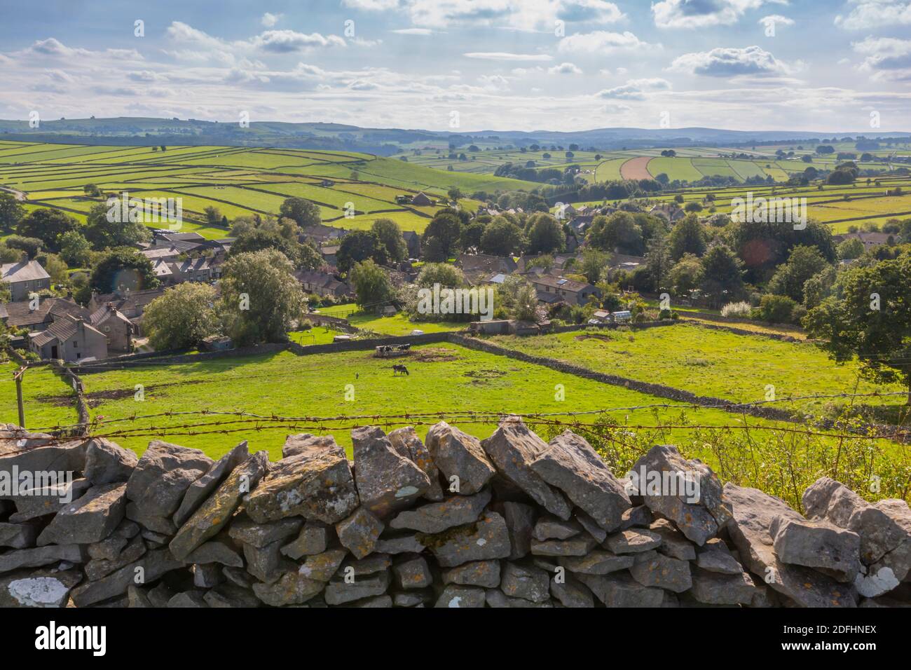 View of dry stone walls and Litton village, Peak District National Park ...