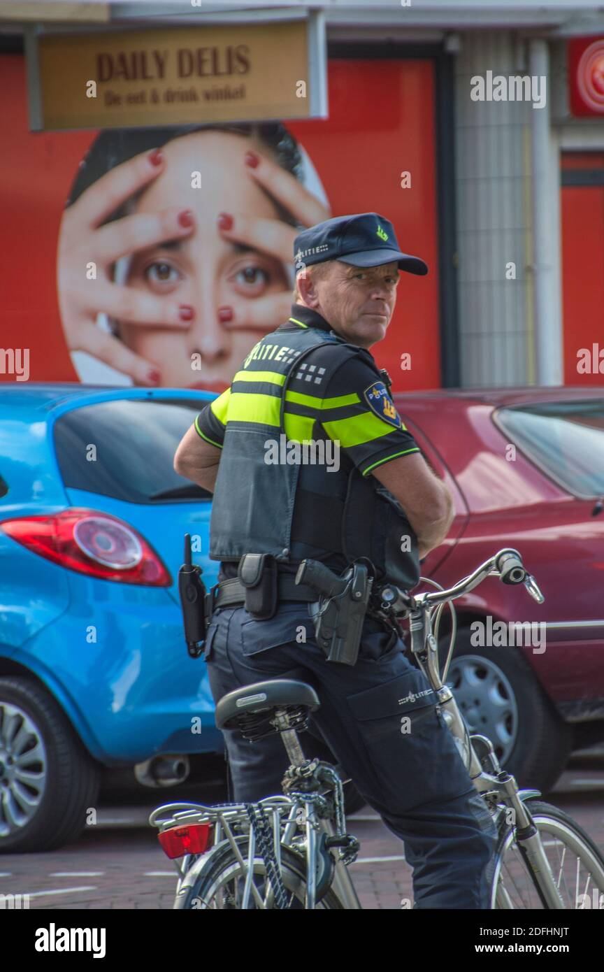 Police Man On Bicycle At Amsterdam East The Netherlands 2018 Stock ...