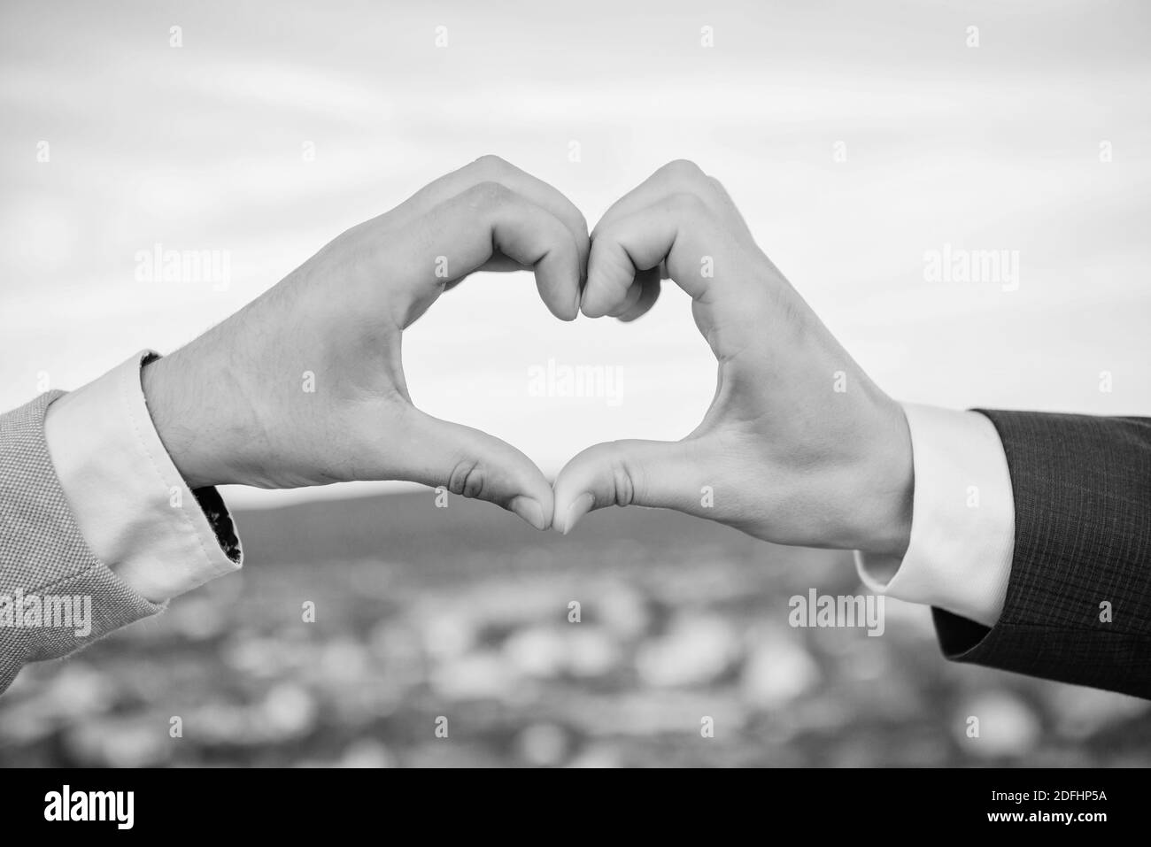 Male hands in heart shape gesture symbol of love and romance. Hands put ...