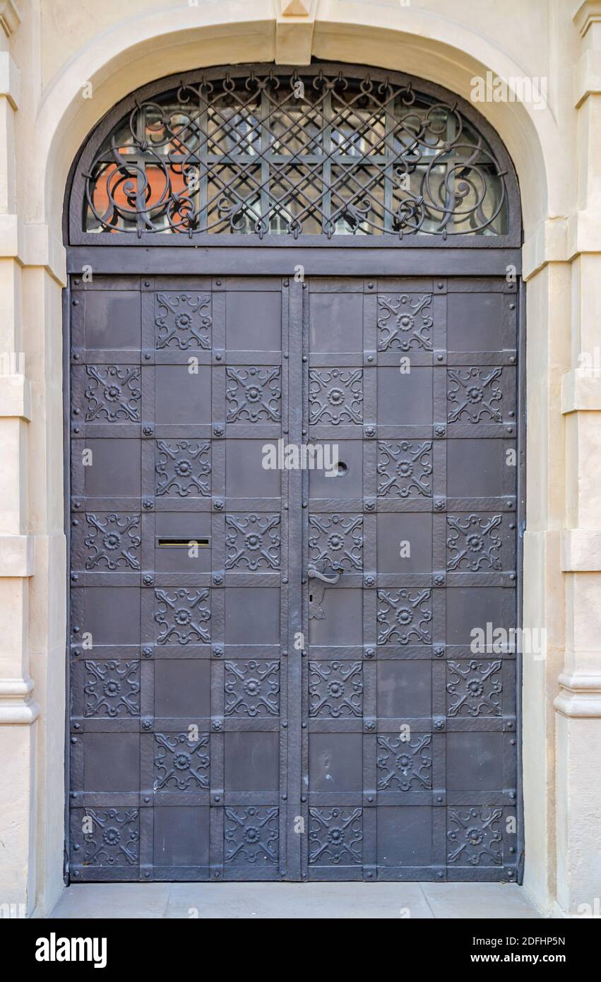 Old dark forged door with lock, wrought-iron metal Stock Photo - Alamy