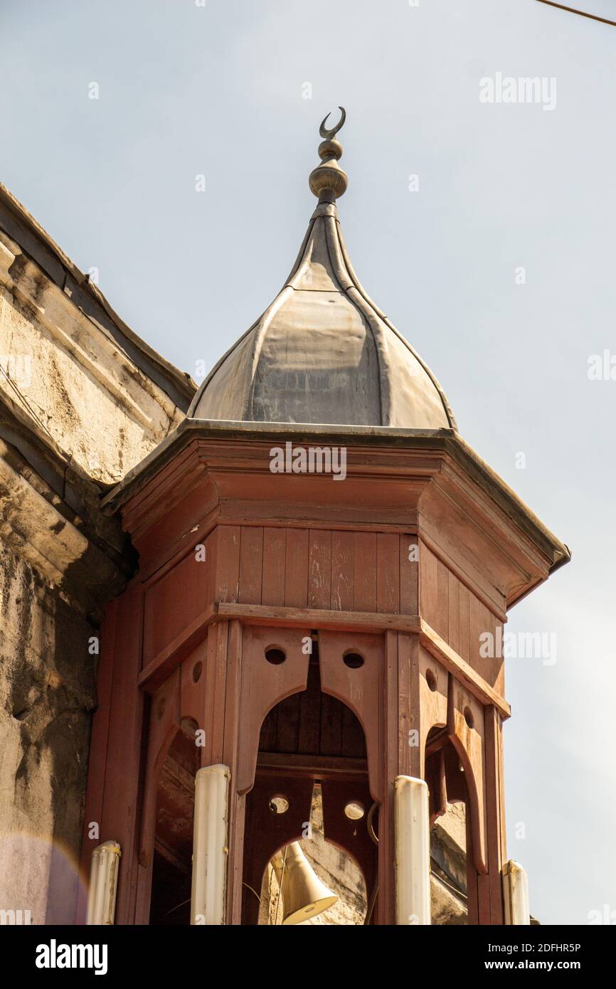 A vertical shot of a Muslim mosque dome with a half moon on top ...