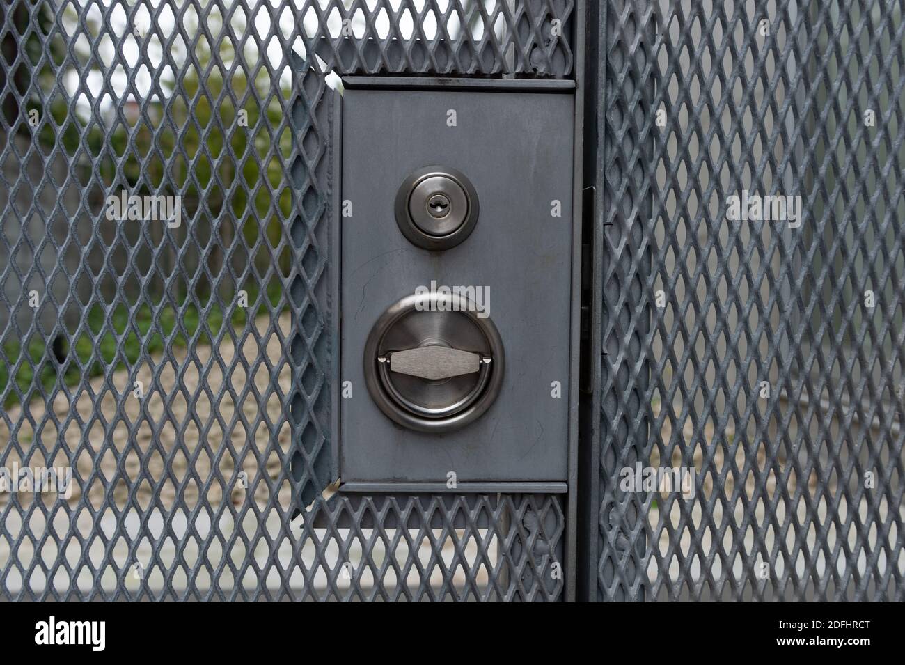 chain link fence and metal door with lock Stock Photo - Alamy