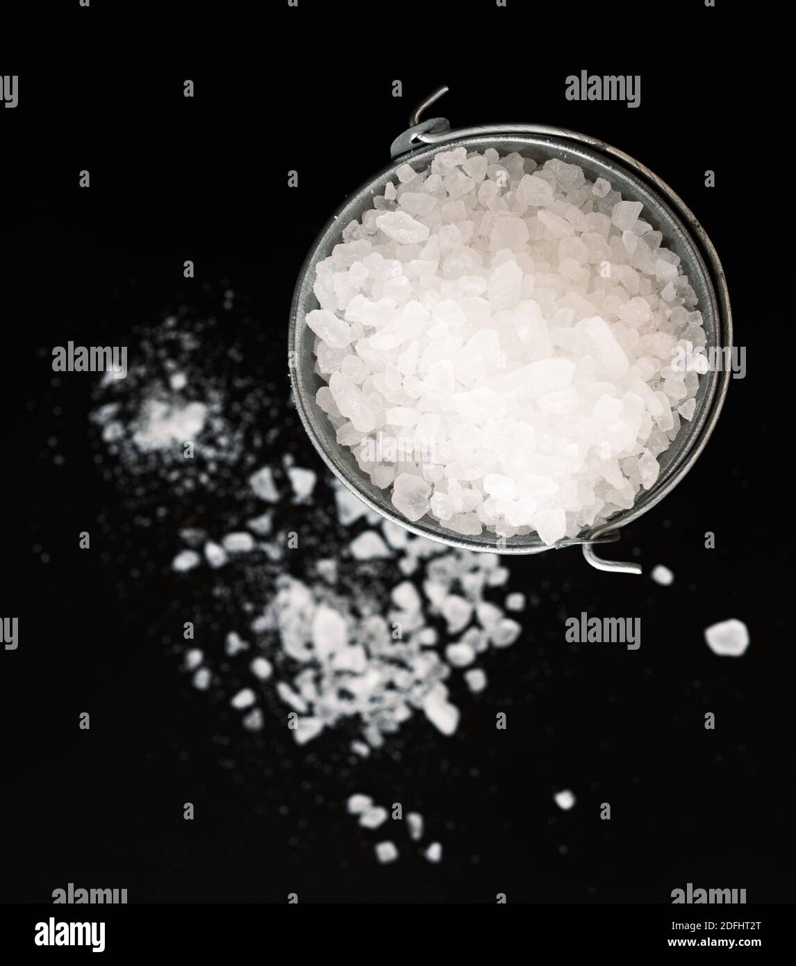 Salt in a bucket on a black background Stock Photo - Alamy
