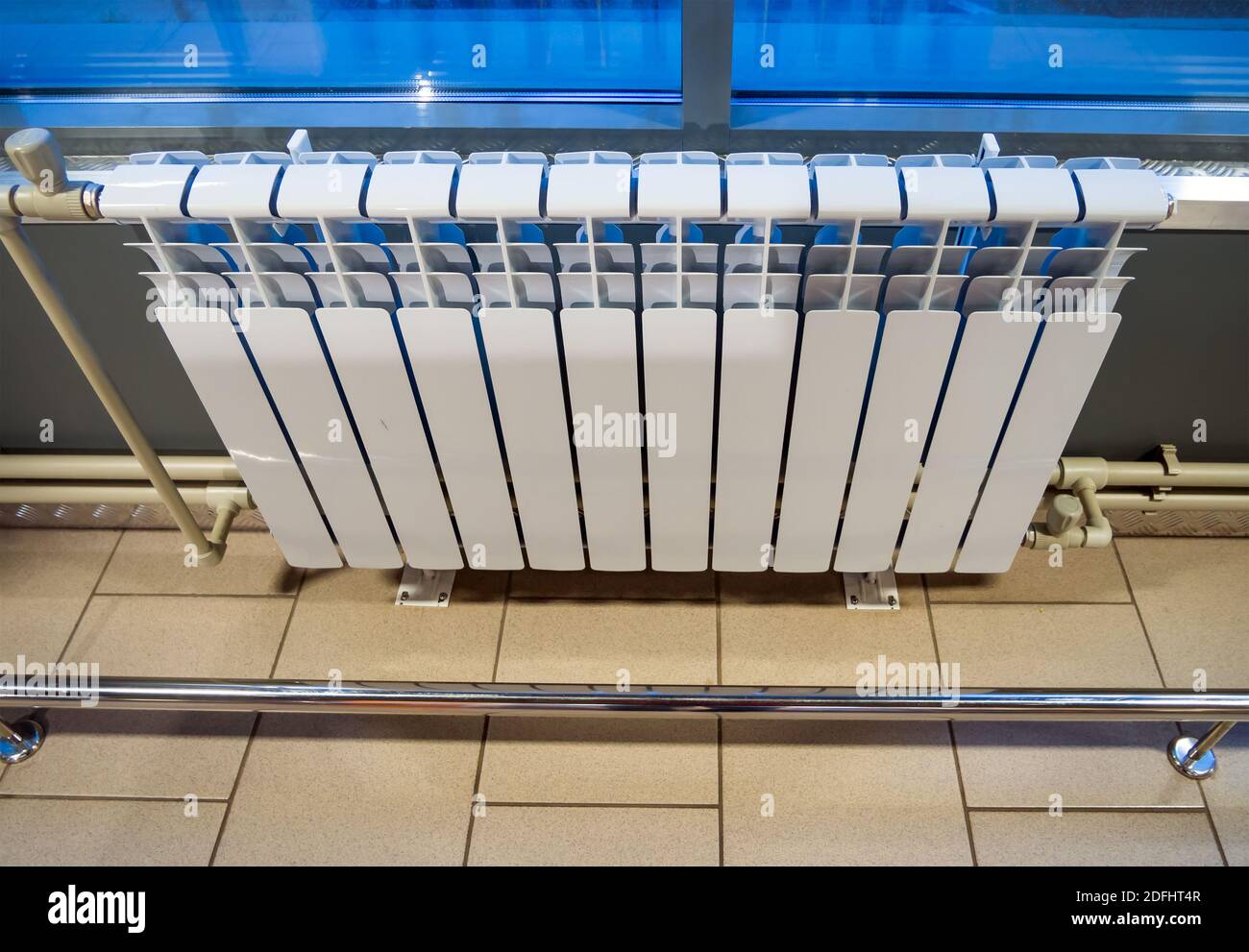 Modern bimetallic heating radiator installed under a window in an ...