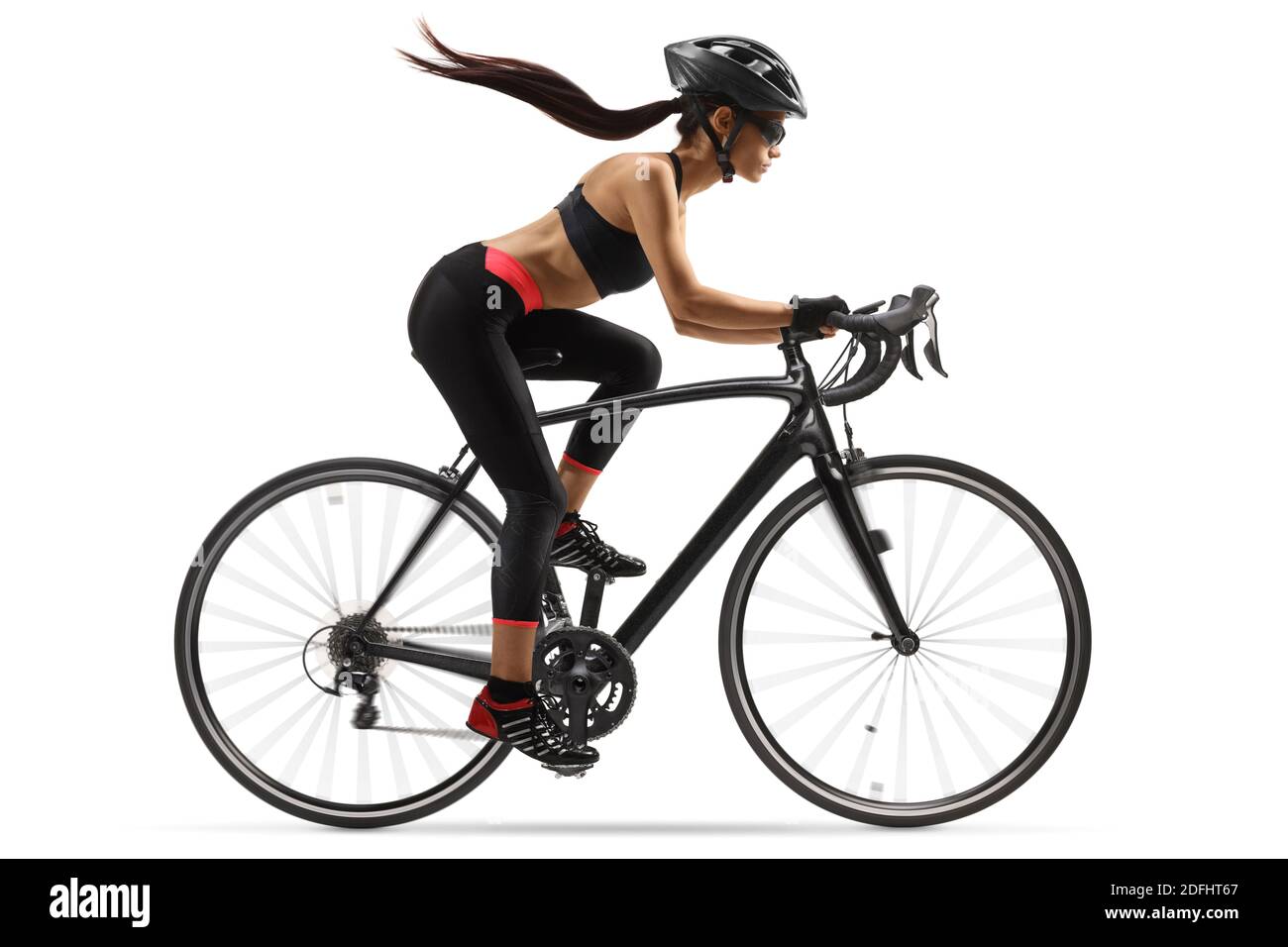 Full length profile shot of a female cyclist with a long hair riding a ...