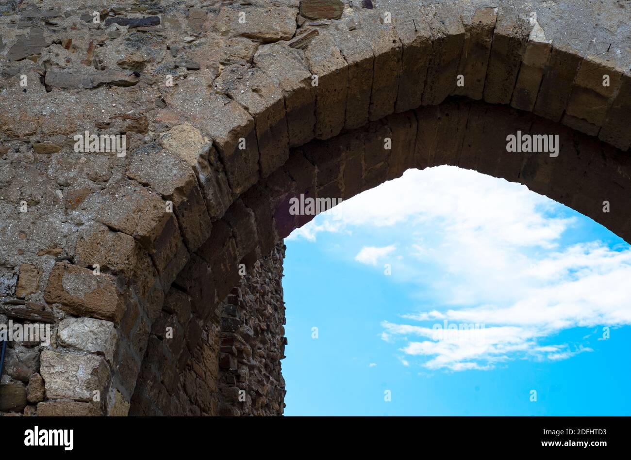 Vaulted arch made of ancient brick and blue sky in the arch. Arches of ...