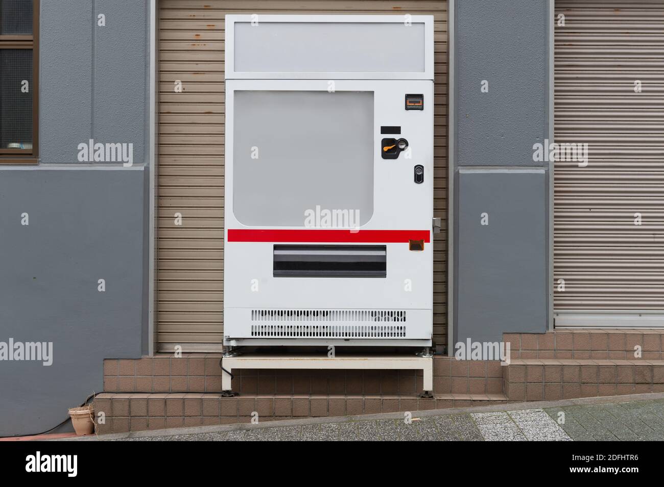 Empty white shelves of standard office vending machine Stock Photo - Alamy