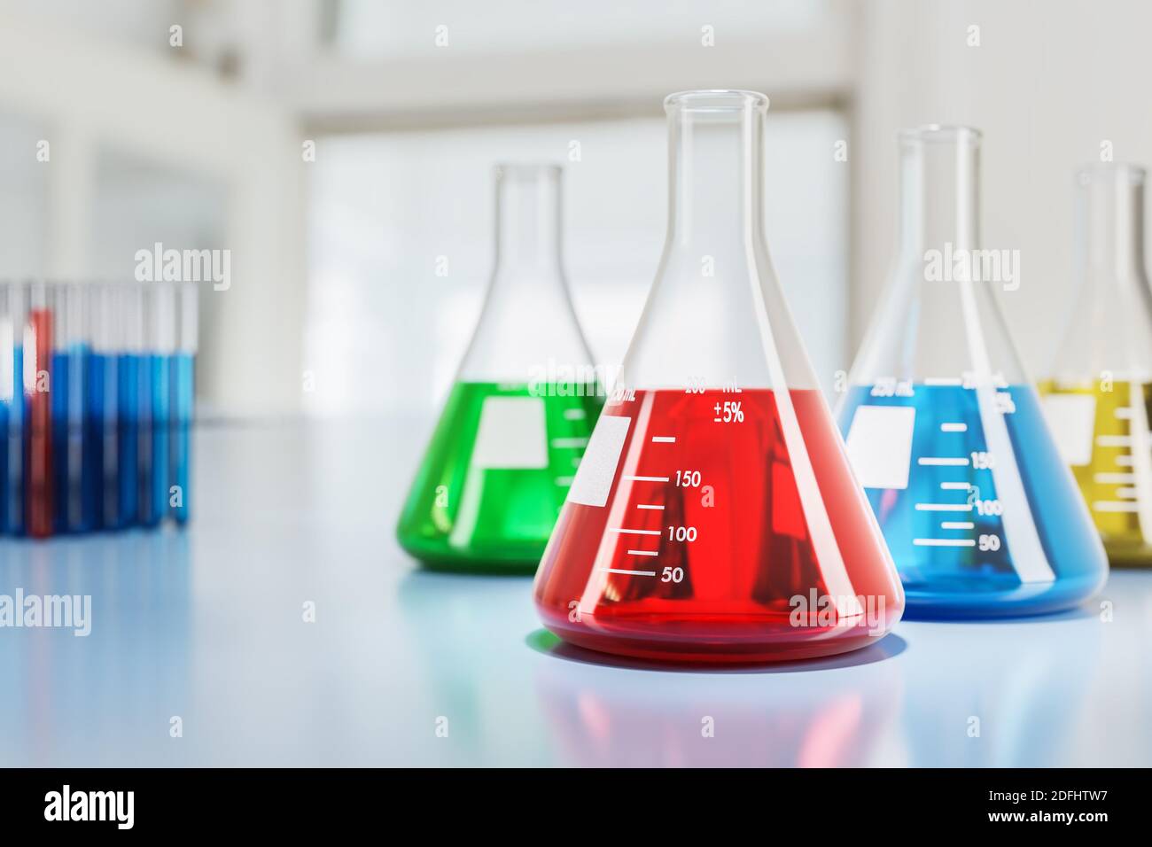 Erlenmeyer flasks with red, blue, green and yellow liquid in a ...