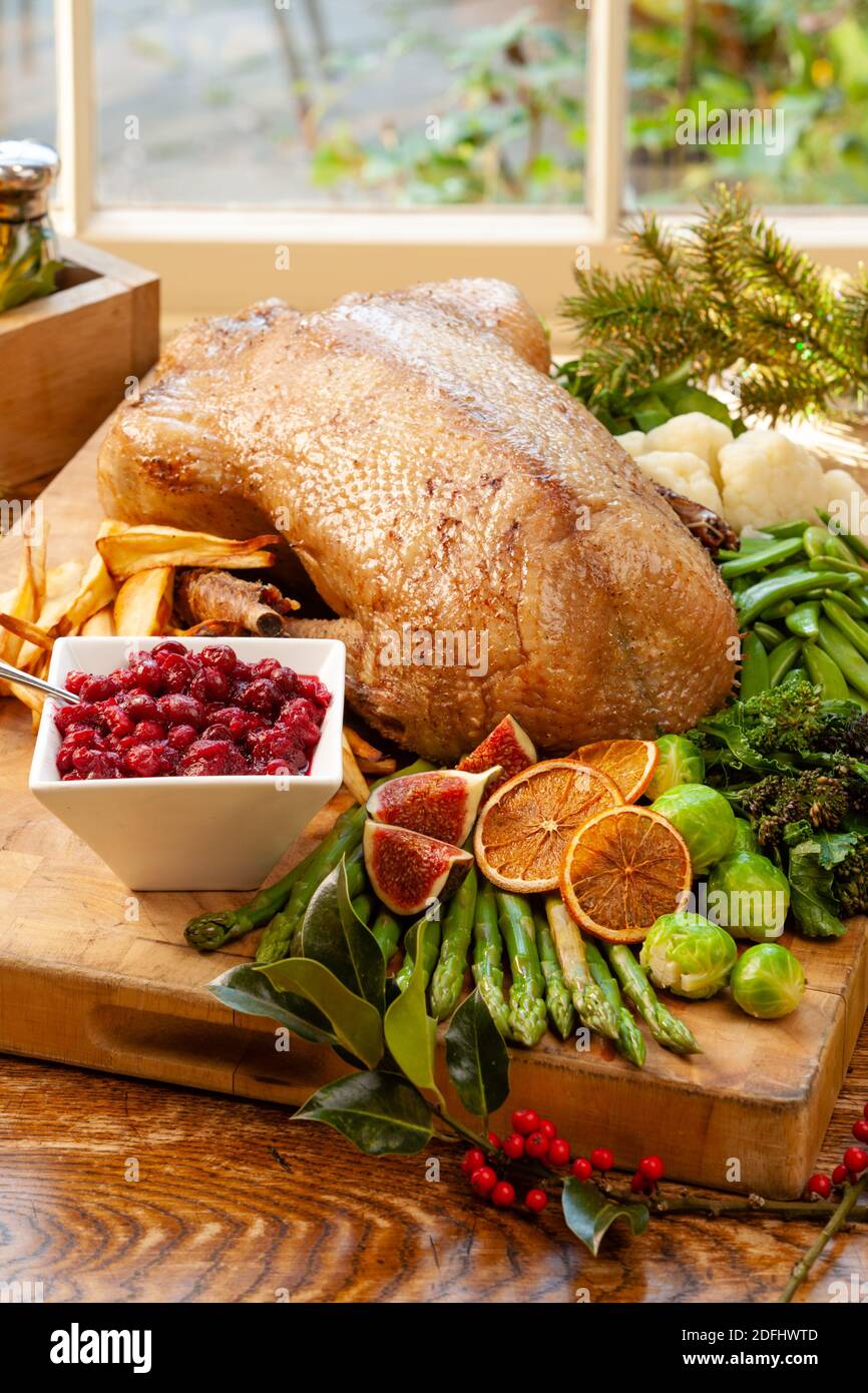 Traditional cooked goose Christmas dinner with fruit, vegetables and ...