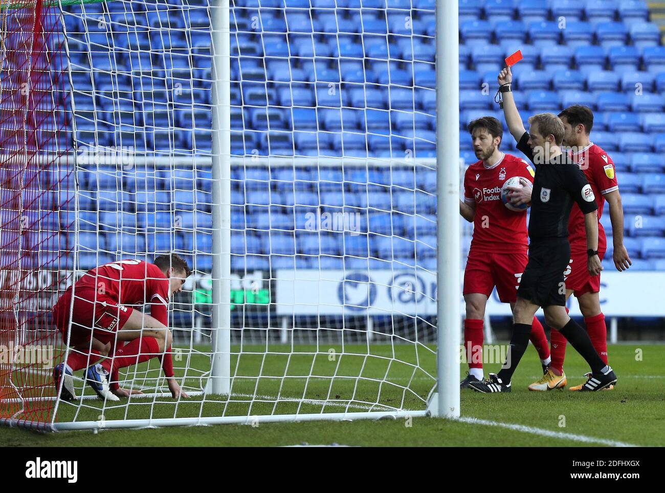 Referee Gavin Ward (right) shows a straight red card to Nottingham ...