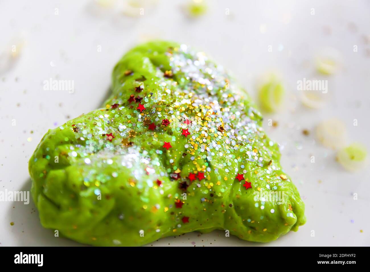 Green heart with shiny glitters made from slime by child Stock Photo ...