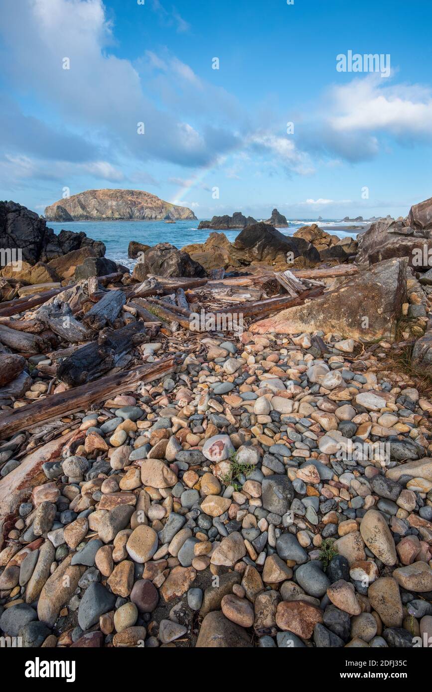 Beach rocks and rainbow at Harris Beach State Park on the southern ...