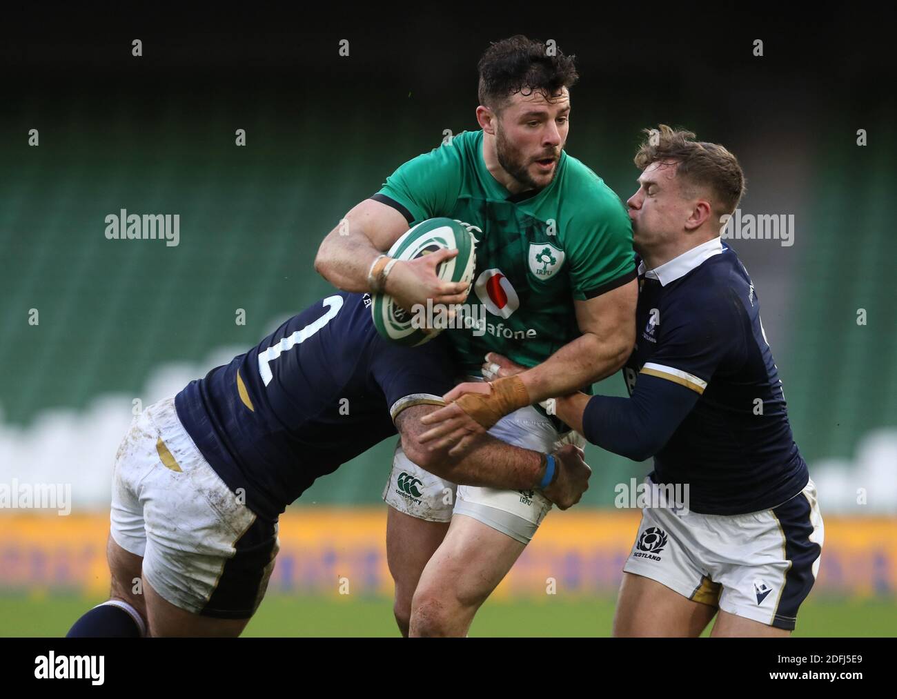 Ireland's Robbie Henshaw (centre) tackled by Scotland's Fraser Brown ...