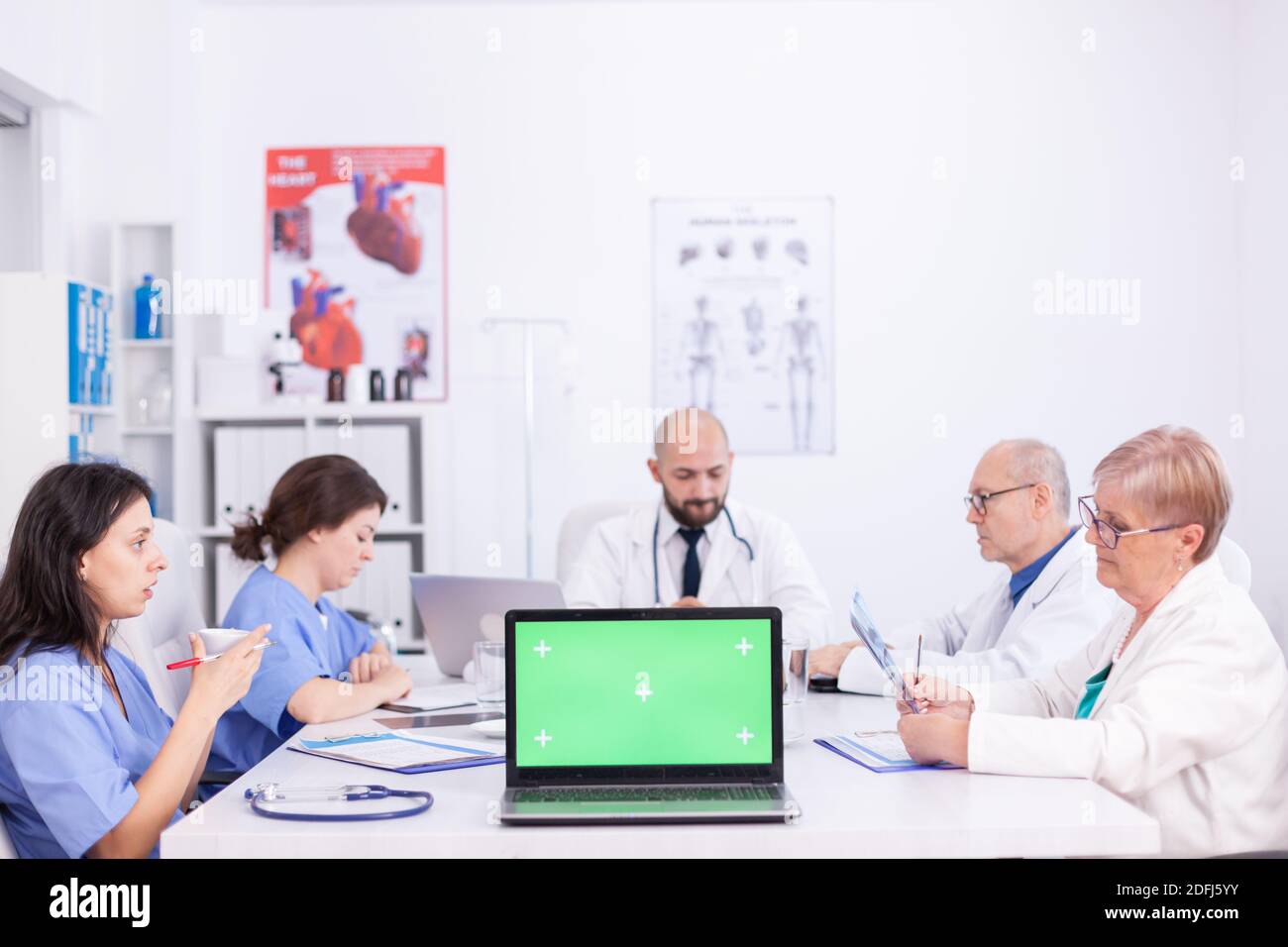 Laptop monitor with green screen in hospital conference. Clinic expert ...