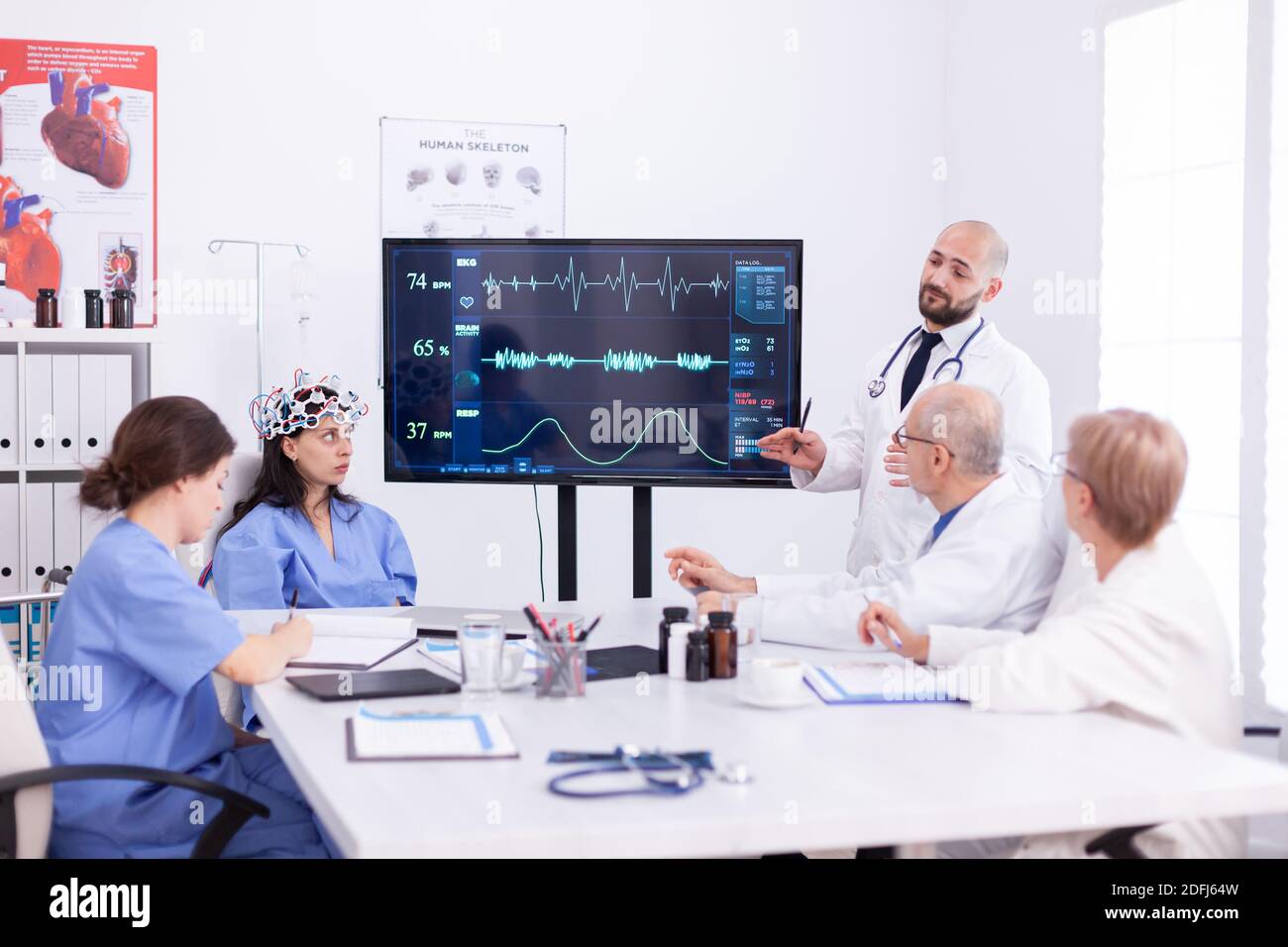Doctor discussing about the future of neurology with medical staff in ...