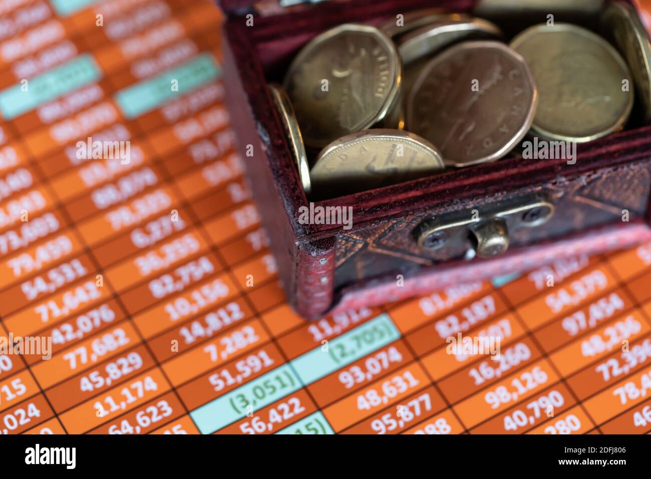 Spreadsheet and Treasure Chest full of Canadian Dollar Coins Stock ...