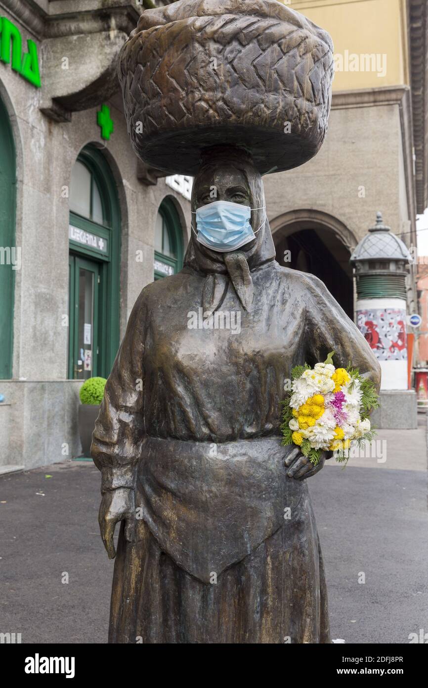 Stature of the peasant woman on the market with face mask Stock Photo ...