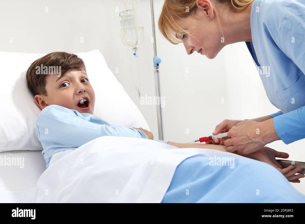 Afraid child lying in bed in hospital room screaming scared by the ...