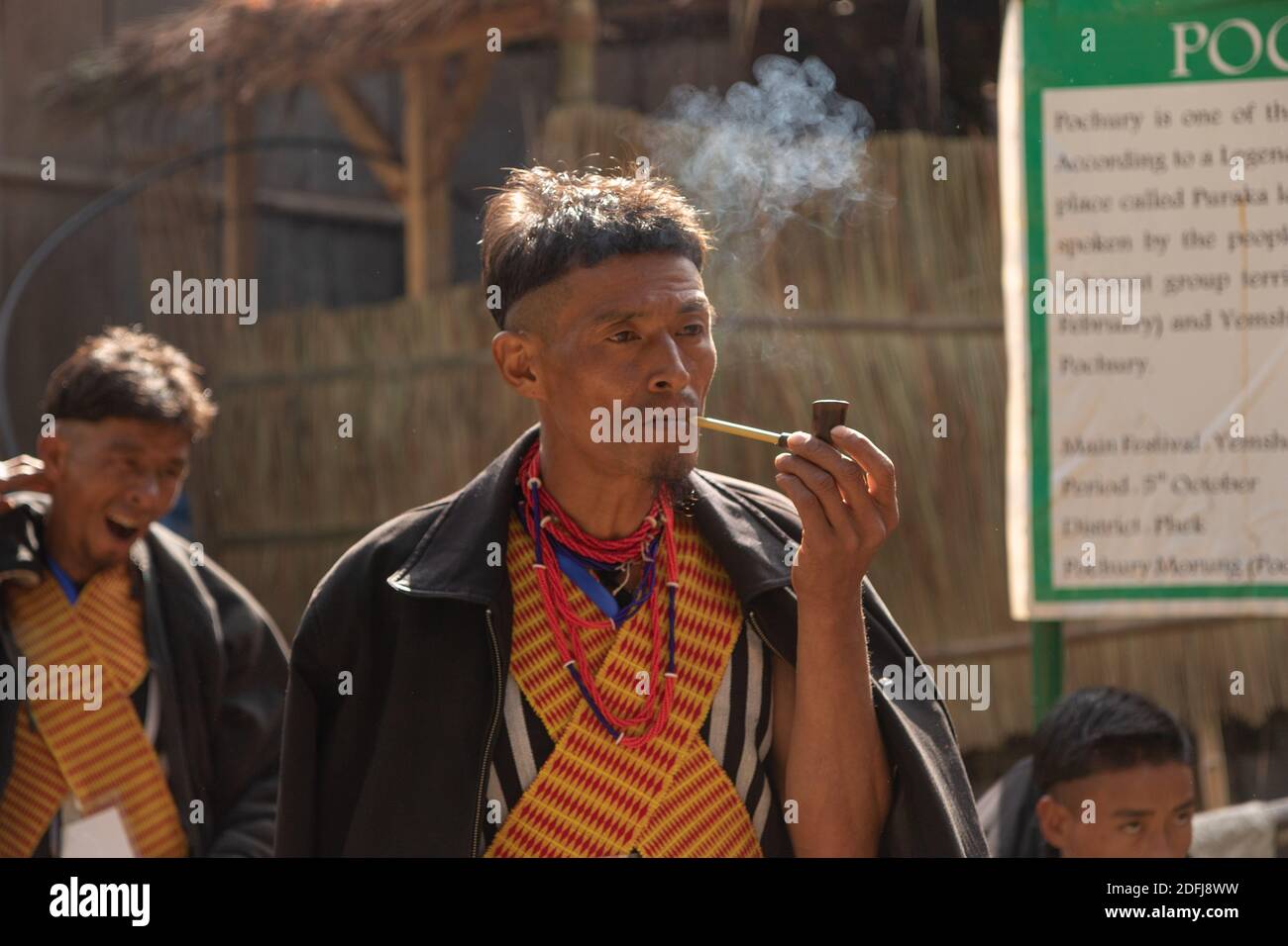 A Naga Tribesman smoking a pipe at Kisama village in Nagaland India on ...