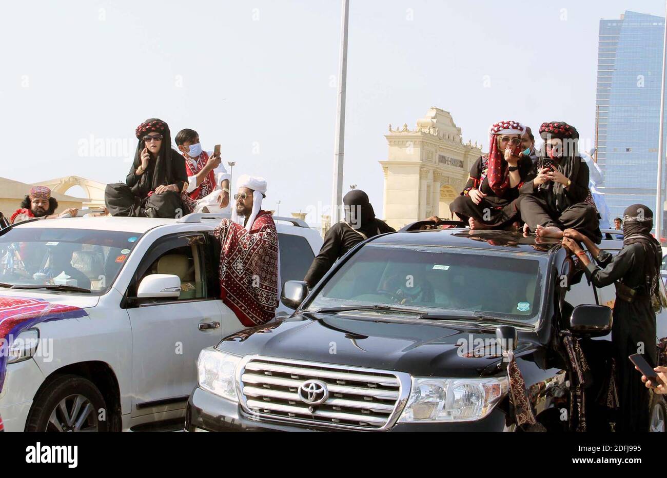 People are wearing Sindh traditional dresses as they holding ...
