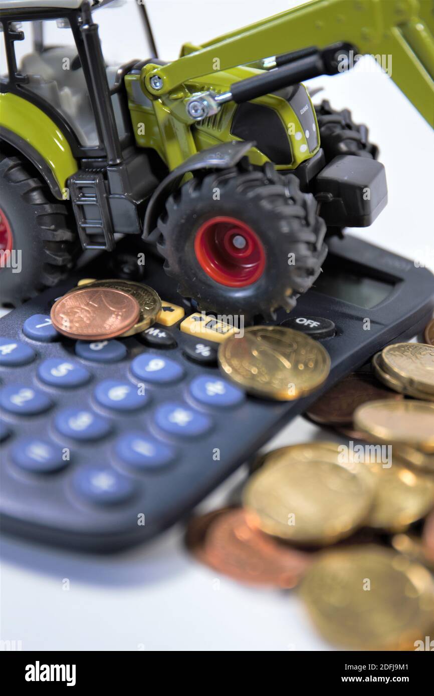 tractor and coins Stock Photo - Alamy