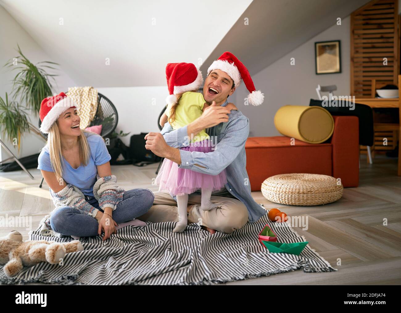 Young family happy about New Year celebration in a holiday atmosphere ...