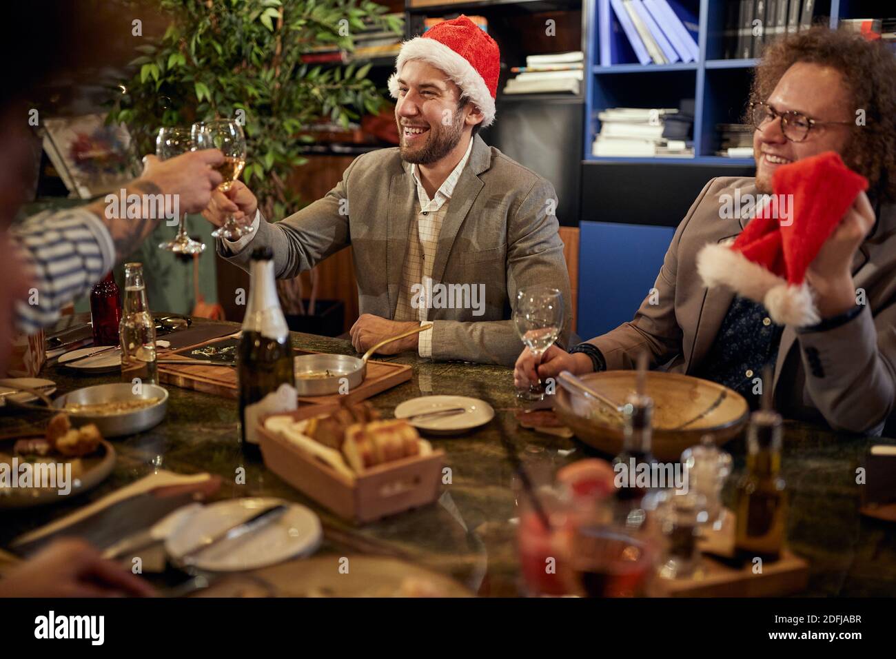 business dinner at Christmas. men drinking, toasting, celebrating with ...