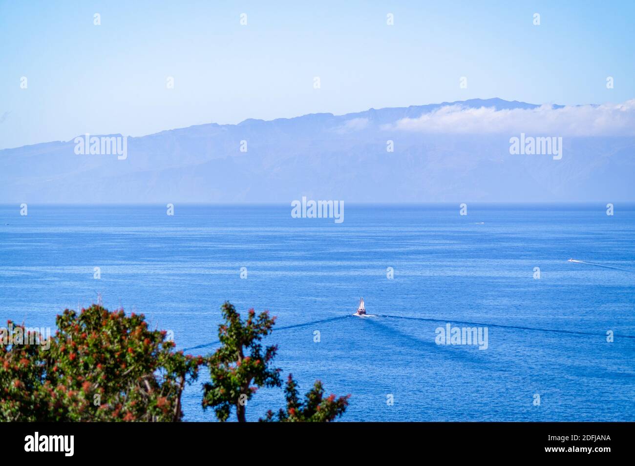 boat driving out to an island in the sea Stock Photo - Alamy