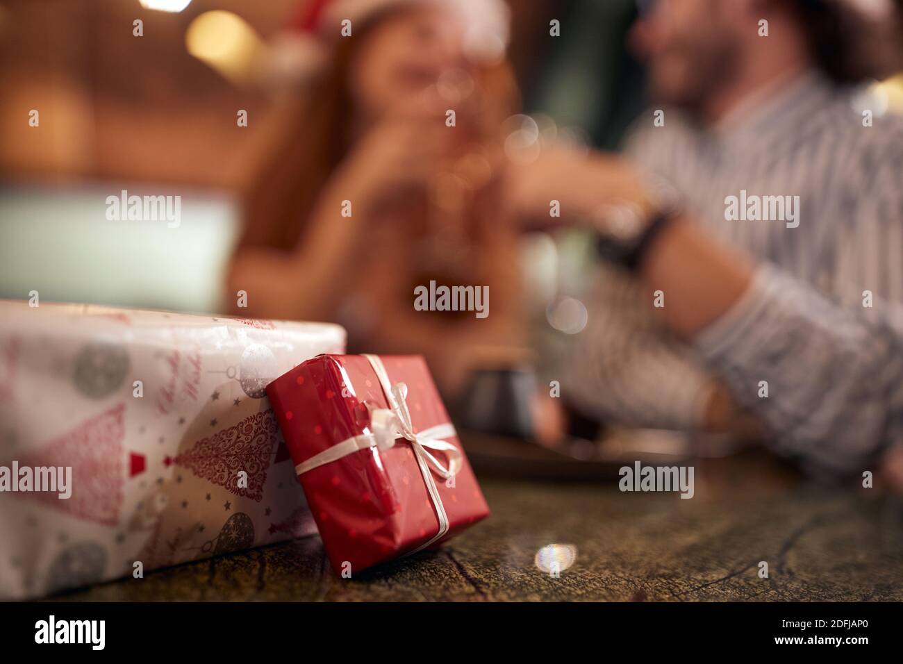 A young couple in love celebrating Xmas together at a restaurant in ...