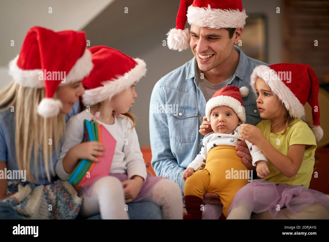 Happy parents spening Christmas time together with their kids; Family ...