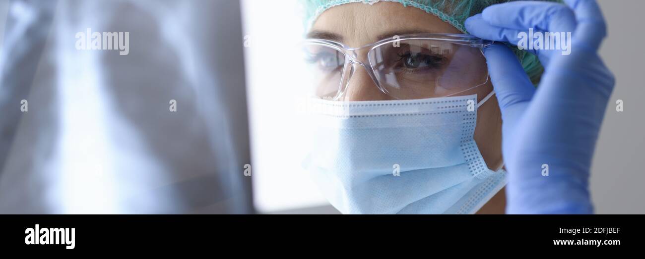 Woman in protective mask and suit hold snapshot of lungs Stock Photo ...