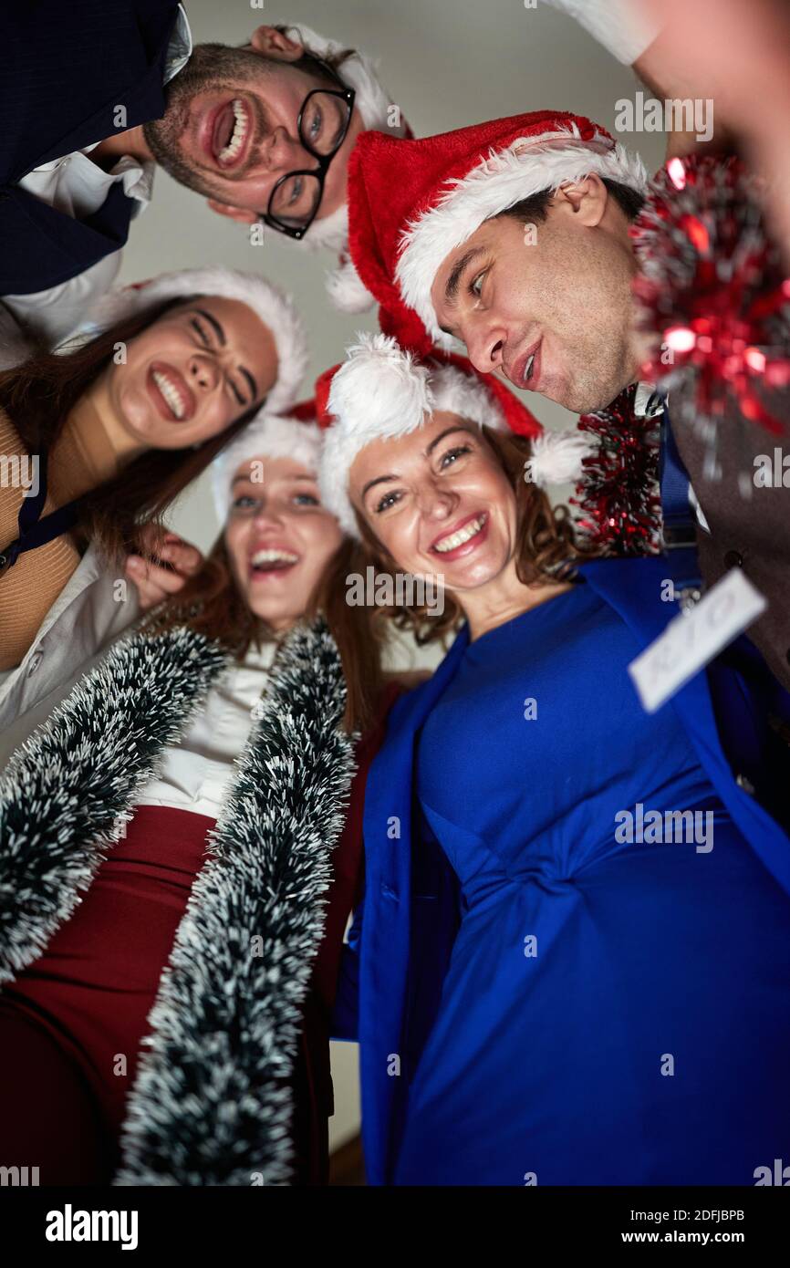 Cheerful group of colleagues celebrating end of an successful year ...