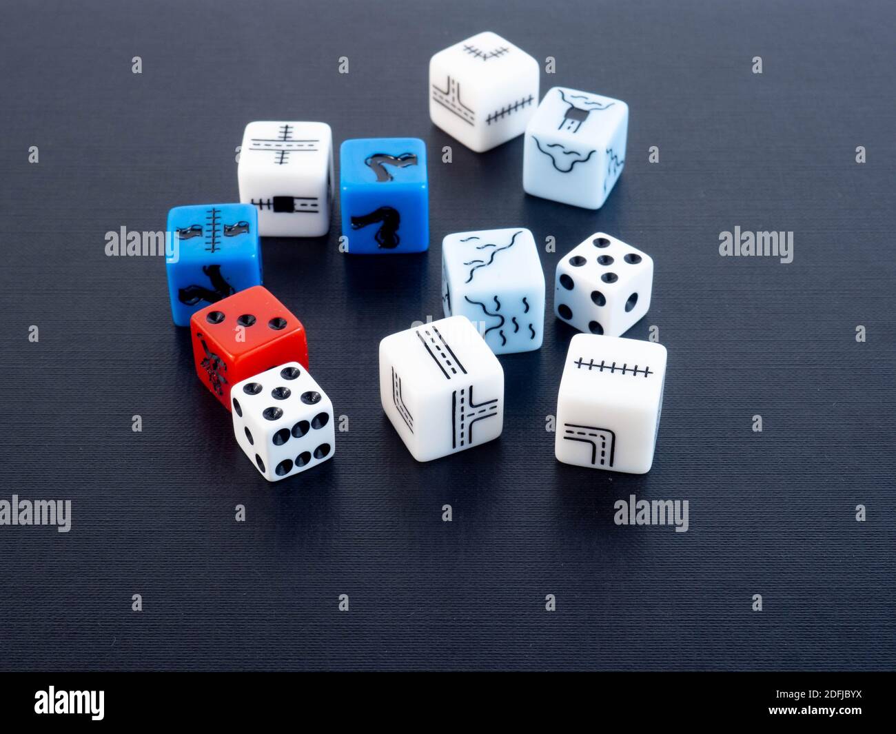 Set of several dice of different colors and shapes on a black ...
