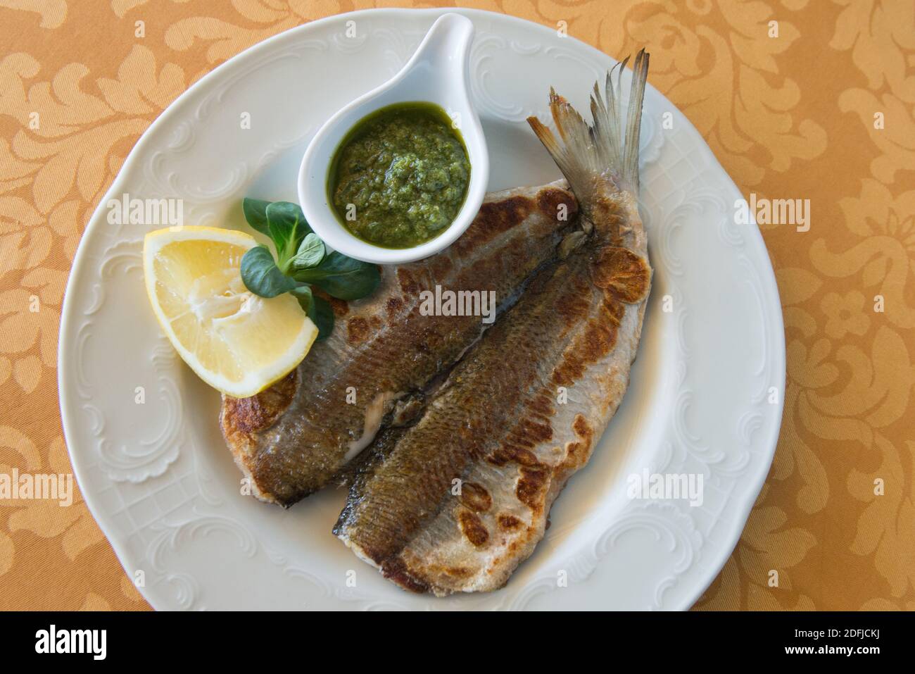 Lavarello in salsa verde,lake como traditional,fish Stock Photo - Alamy