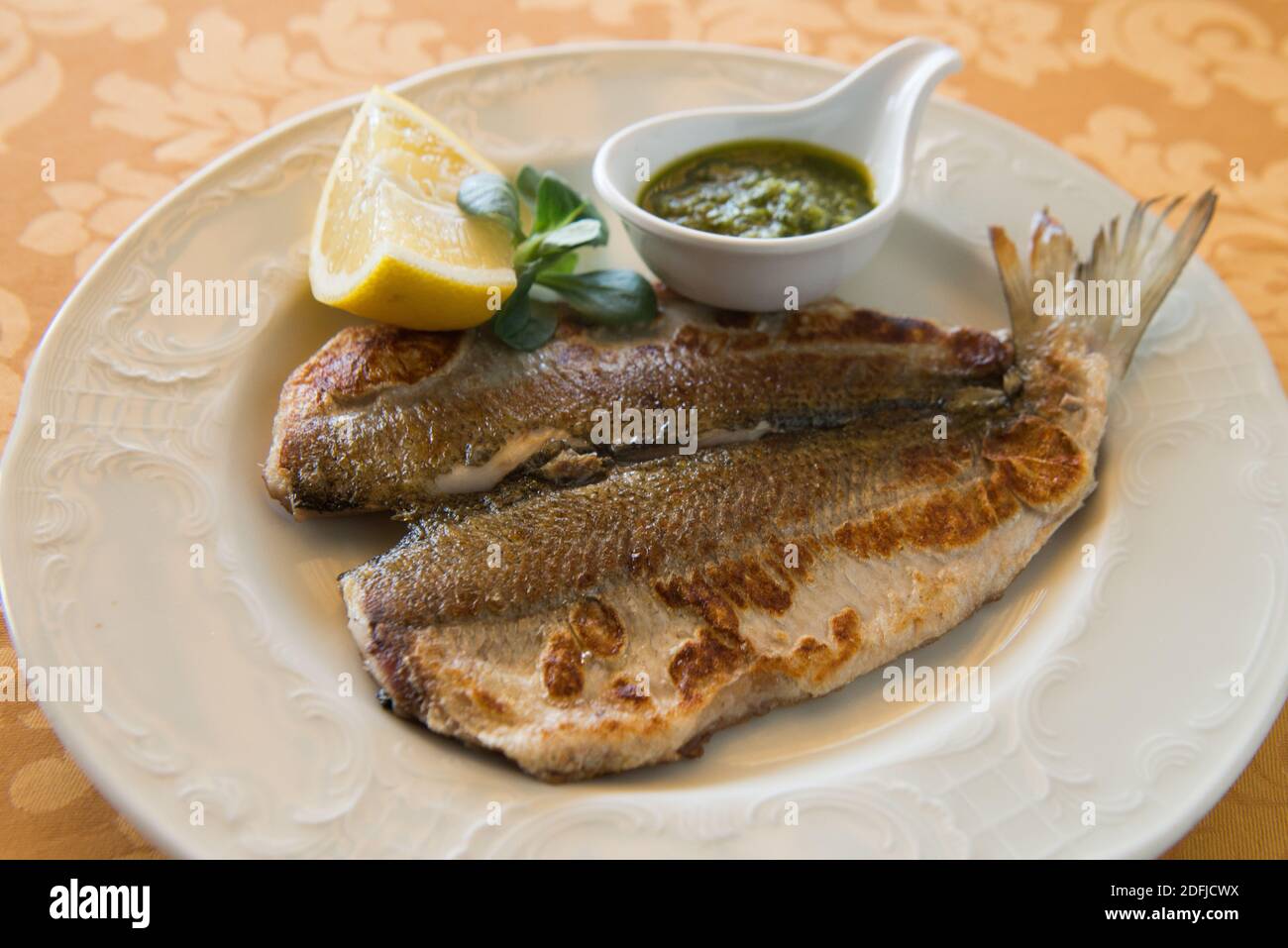 Lavarello in salsa verde,lake como traditional,fish Stock Photo - Alamy