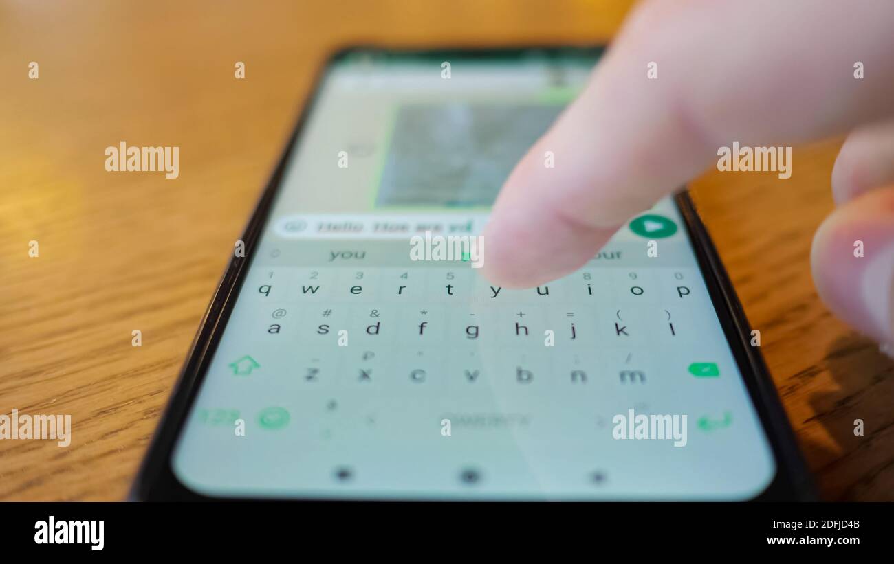 male hand typing a message on the phone Stock Photo - Alamy