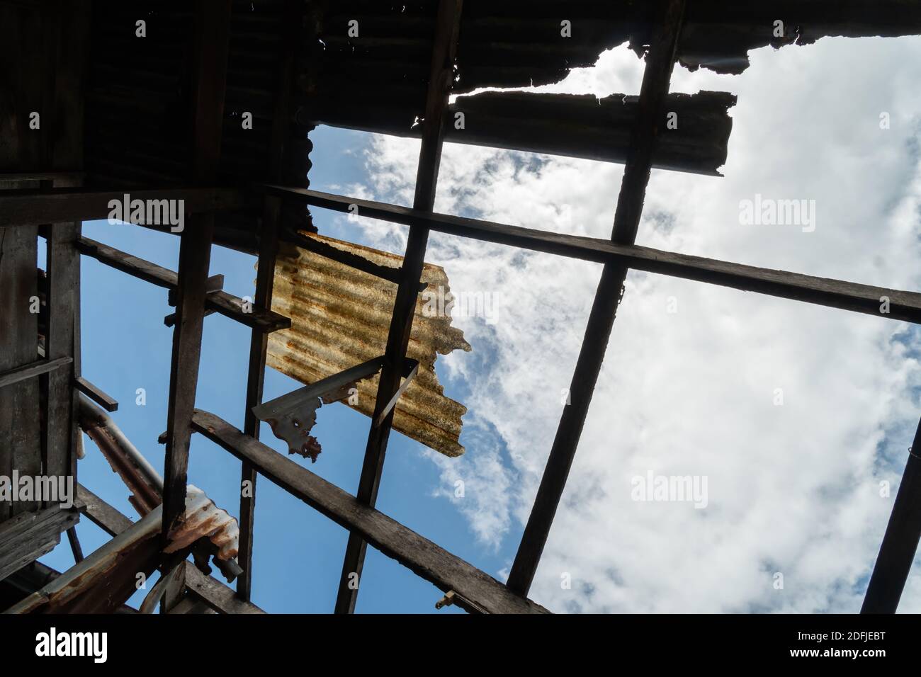 Old damage roof with blue sky and clouds images Stock Photo - Alamy