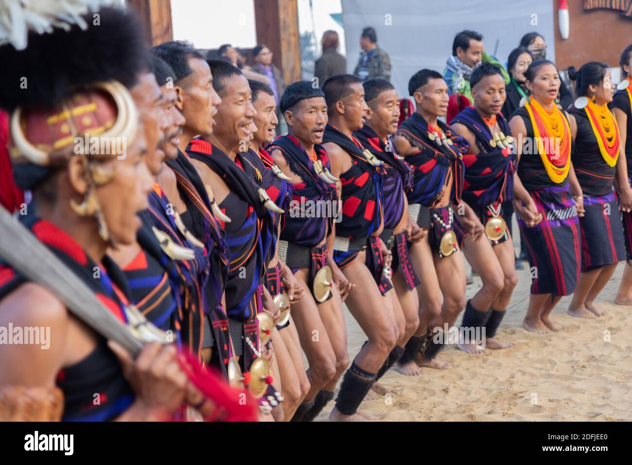 A group of naga tribesmen and women dressed in their traditional attire ...
