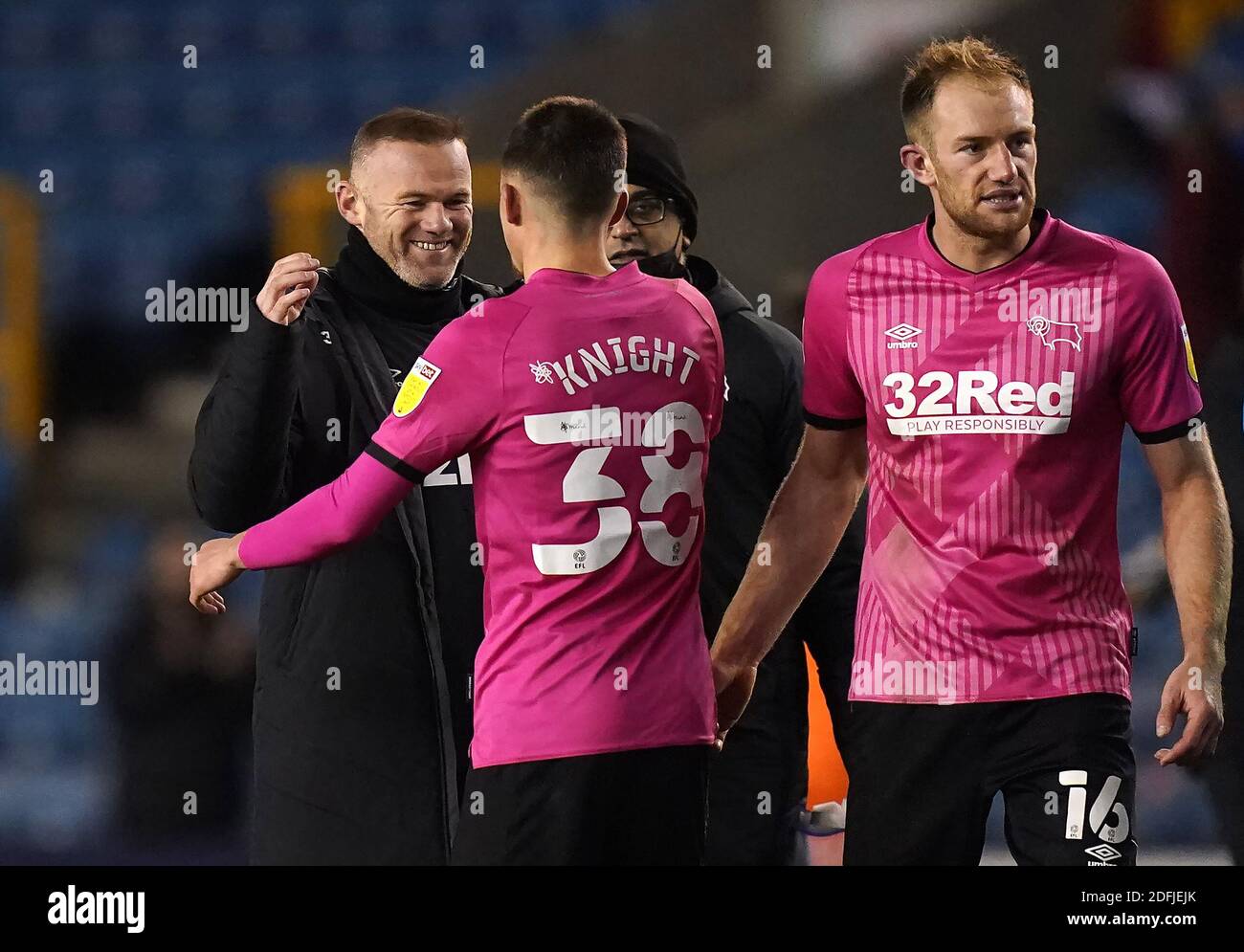 Derby County interim manager Wayne Rooney embraces Jason Knight after ...