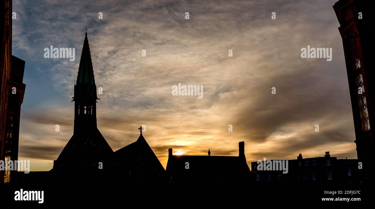 Panoramic image of a sunrise over the Harrow School with silhouette of ...