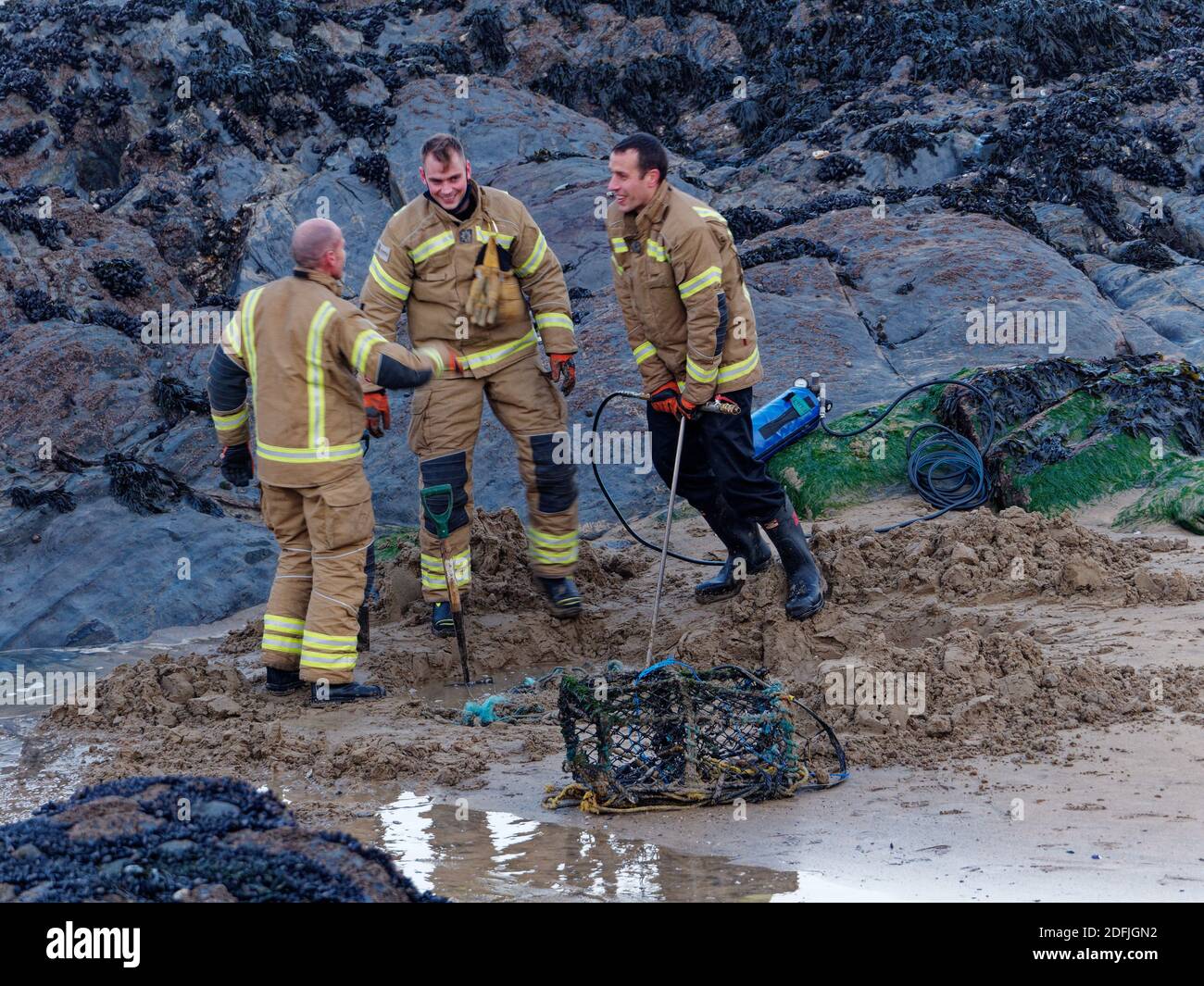 UK Fire Brigade members use lost crab pots buried on beach to practice ...
