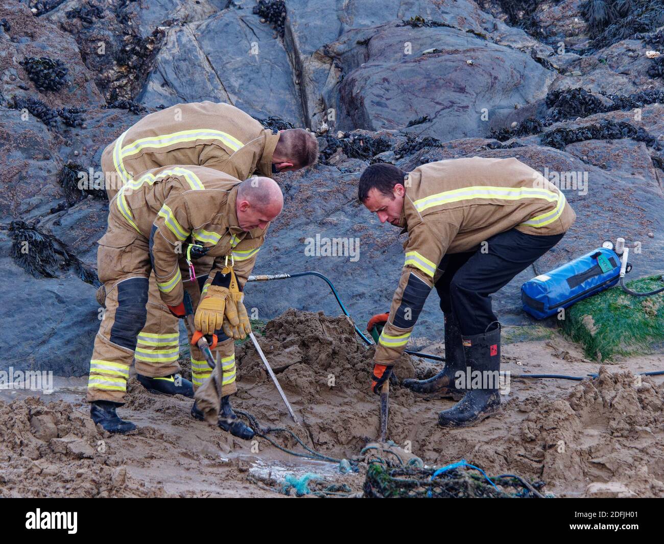 UK Fire Brigade members use lost crab pots buried on beach to practice ...