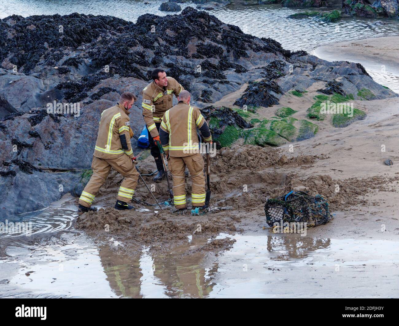 UK Fire Brigade members use lost crab pots buried on beach to practice ...