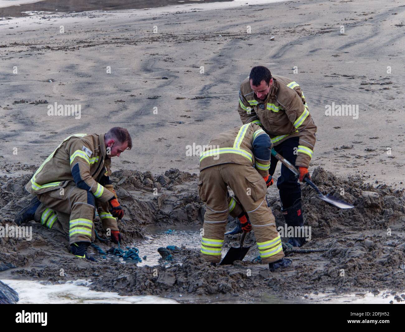 UK Fire Brigade members use lost crab pots buried on beach to practice ...