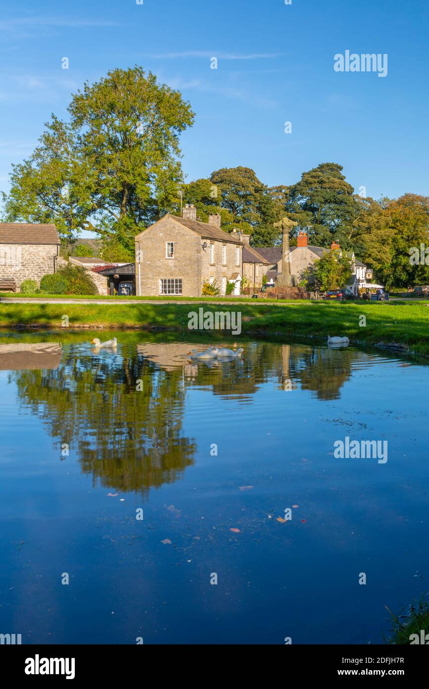 View of reflections in village pond, Foolow, Derbyshire Peak District ...