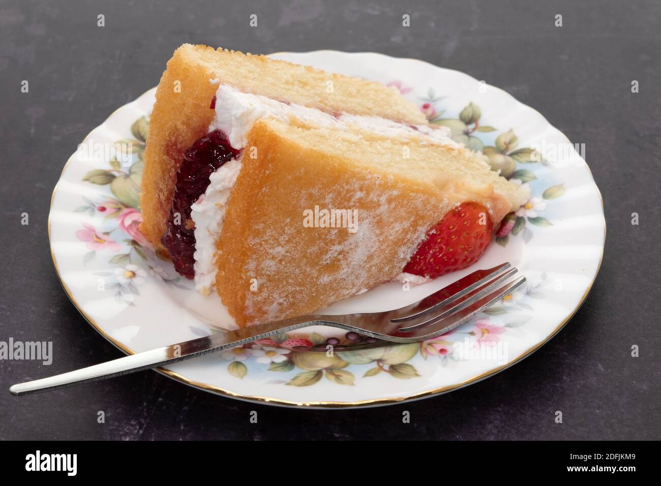 A slice of Victoria sponge cake on an ornate antique plate - white ...