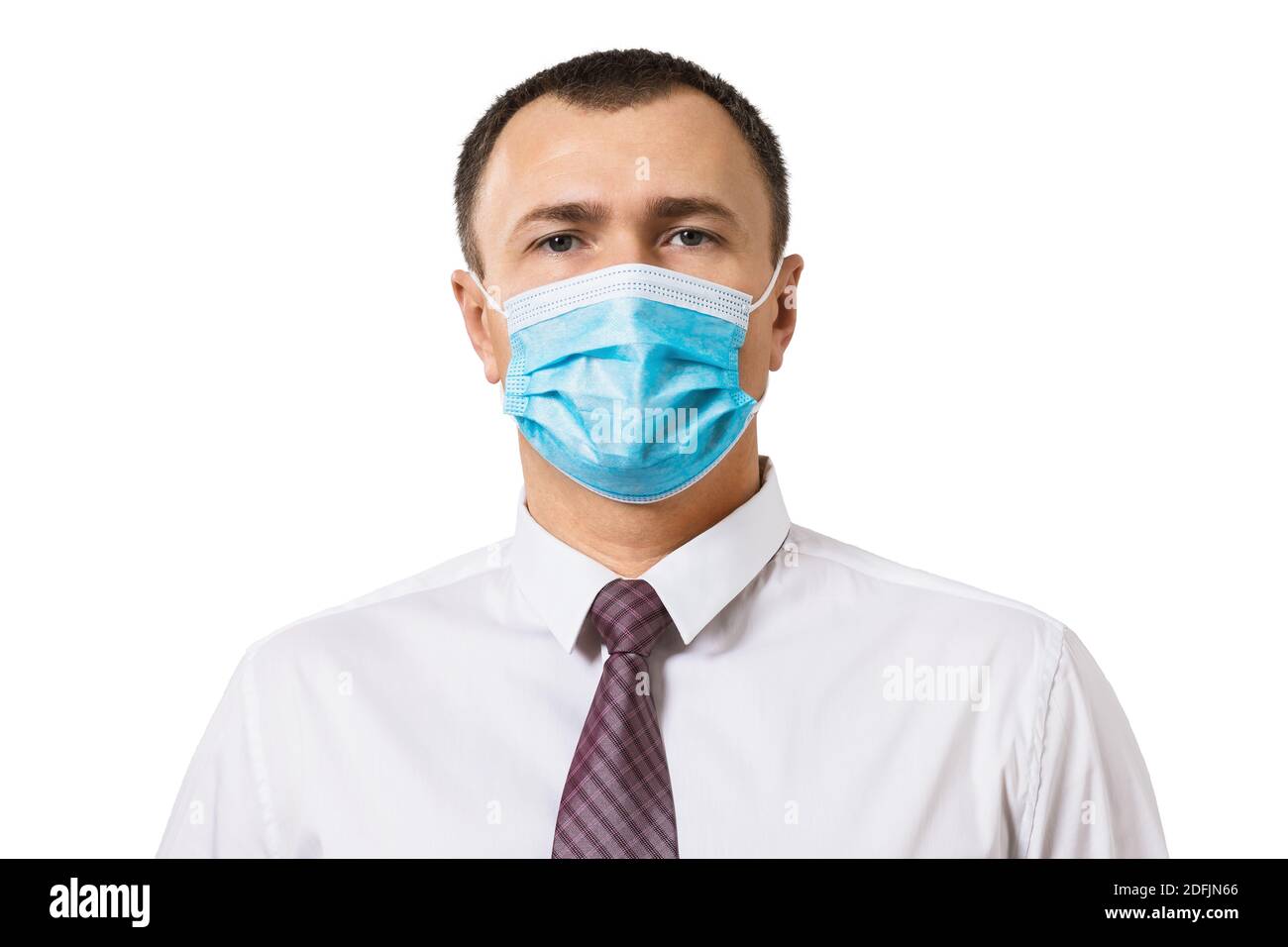 A man in a shirt with a tie and wearing a medical mask on his face ...