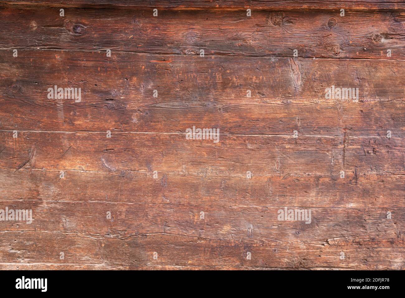 Dark brown weathered wooden plank wall of chalets in the old town of ...